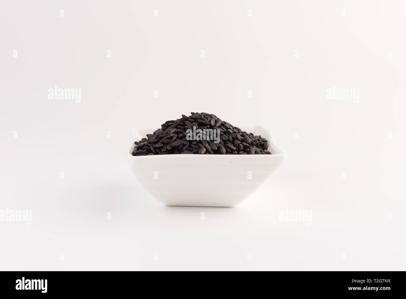 bowl of black wild rice isolated on white background Stock Photo - Alamy