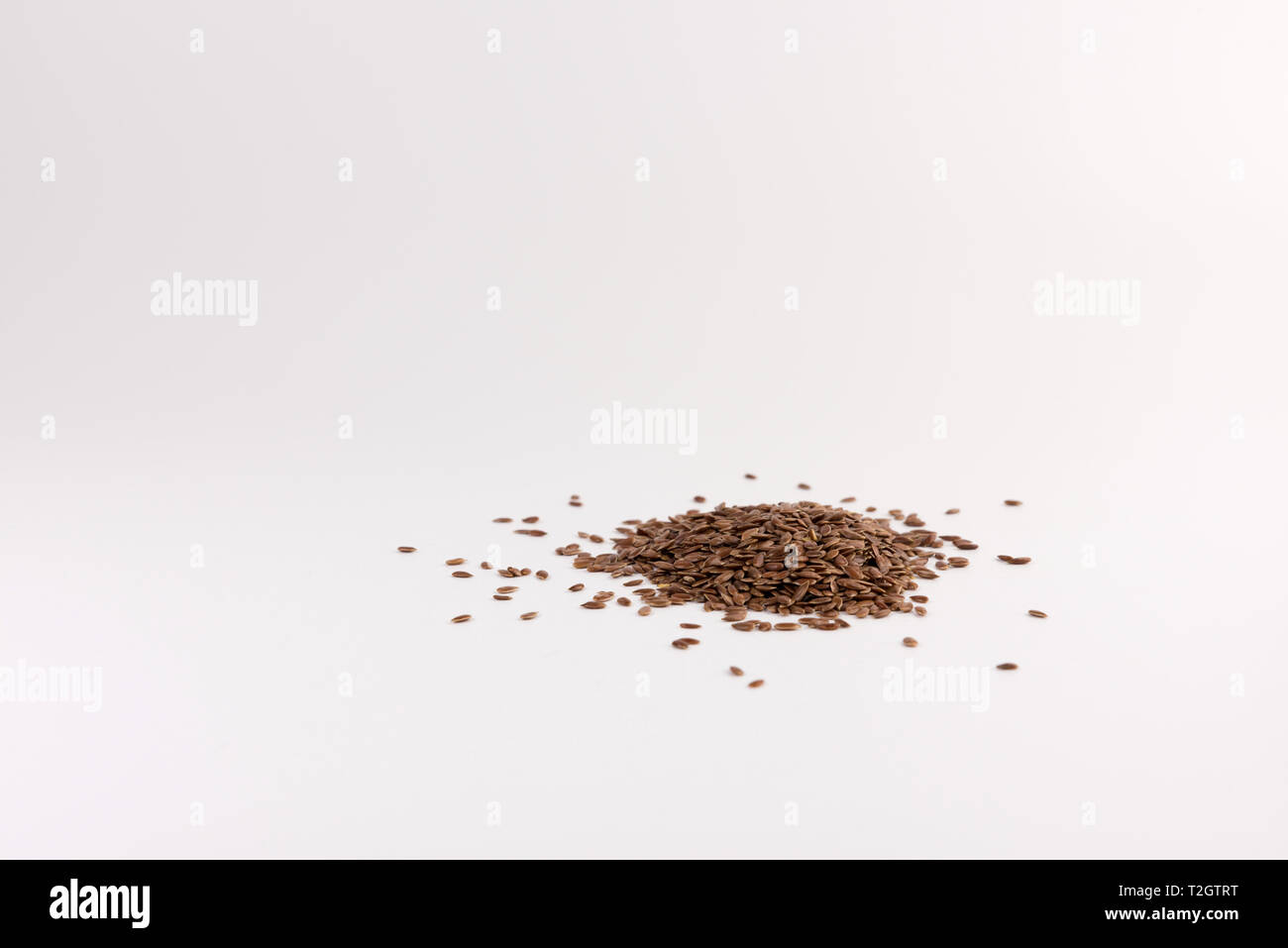pile of flax seeds isolated on white background Stock Photo - Alamy