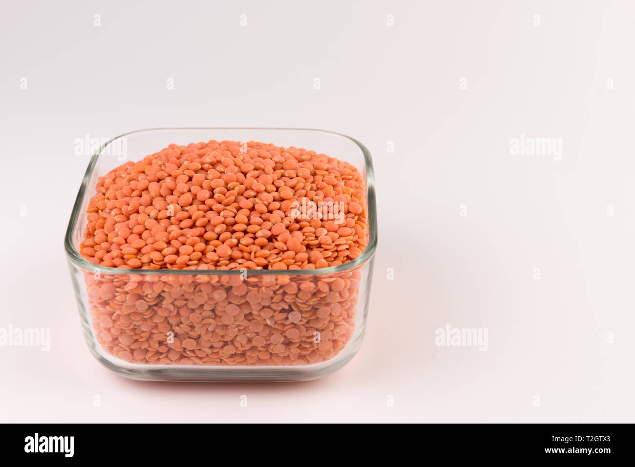 Red lentils in glass plate isolated on white background Stock Photo - Alamy