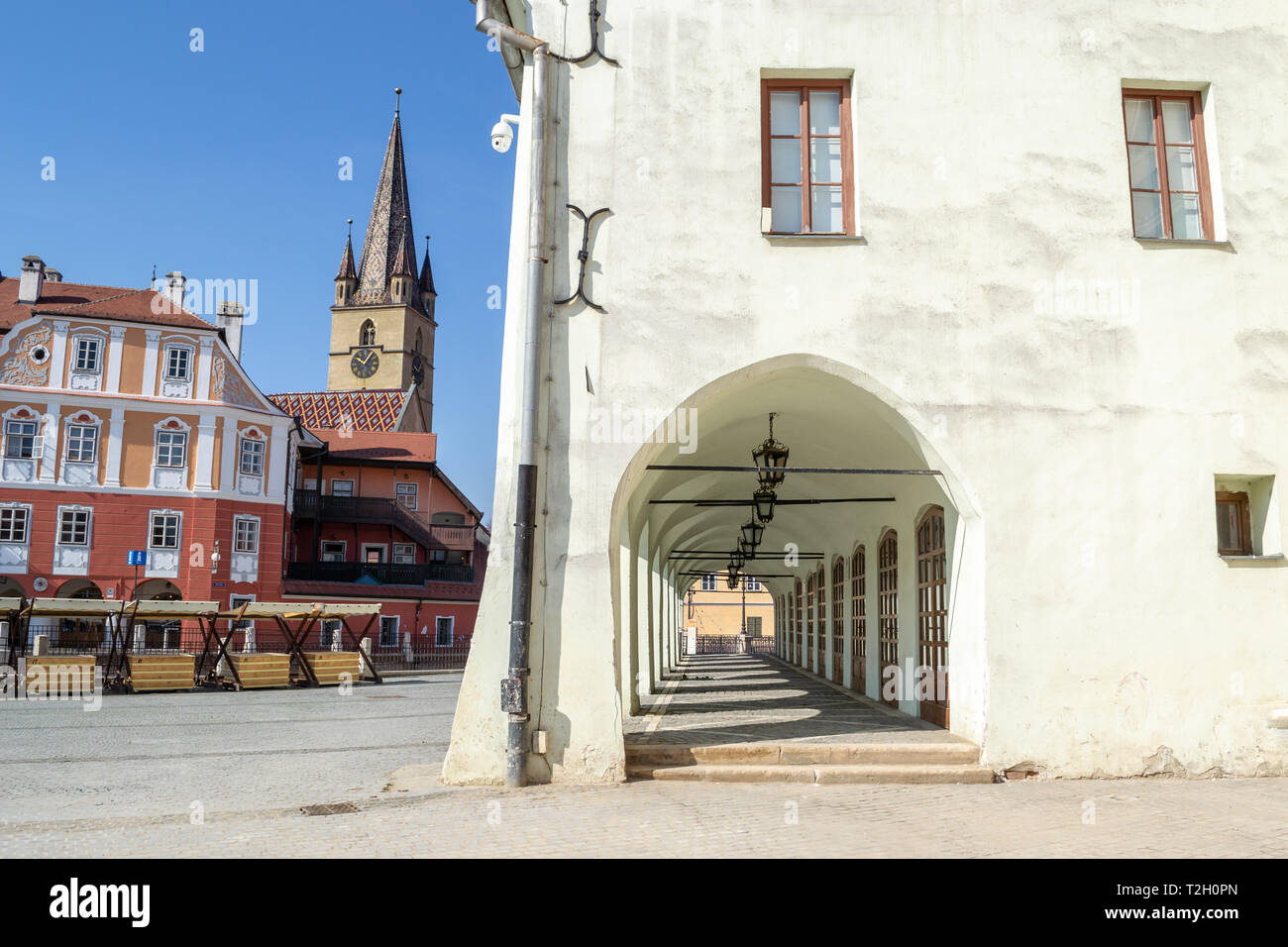 Old, medieval, white building with a corridor with several archways and ...