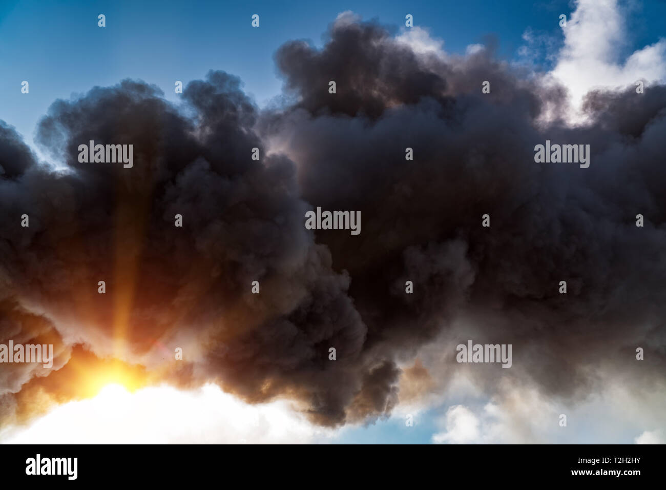 Thick black acrid smoke on the sky background Stock Photo - Alamy