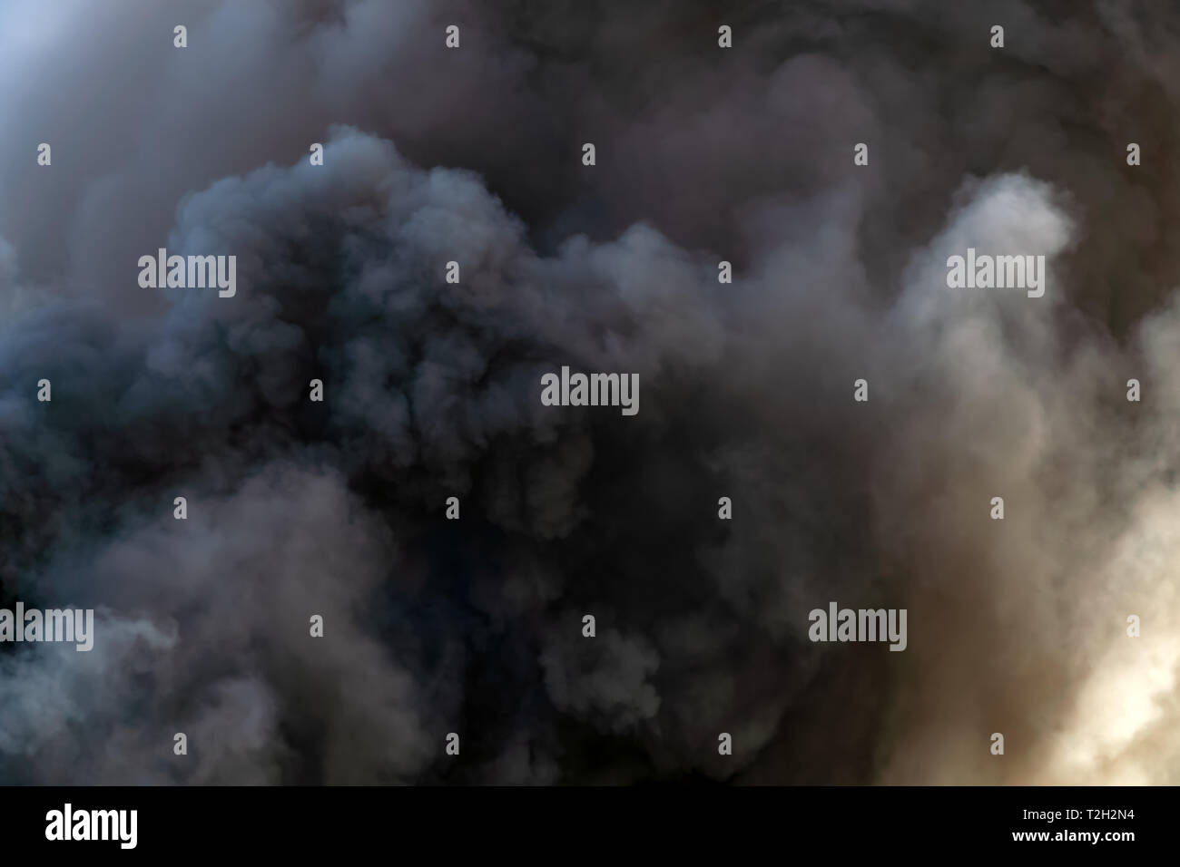 Thick black acrid smoke on the sky background Stock Photo - Alamy