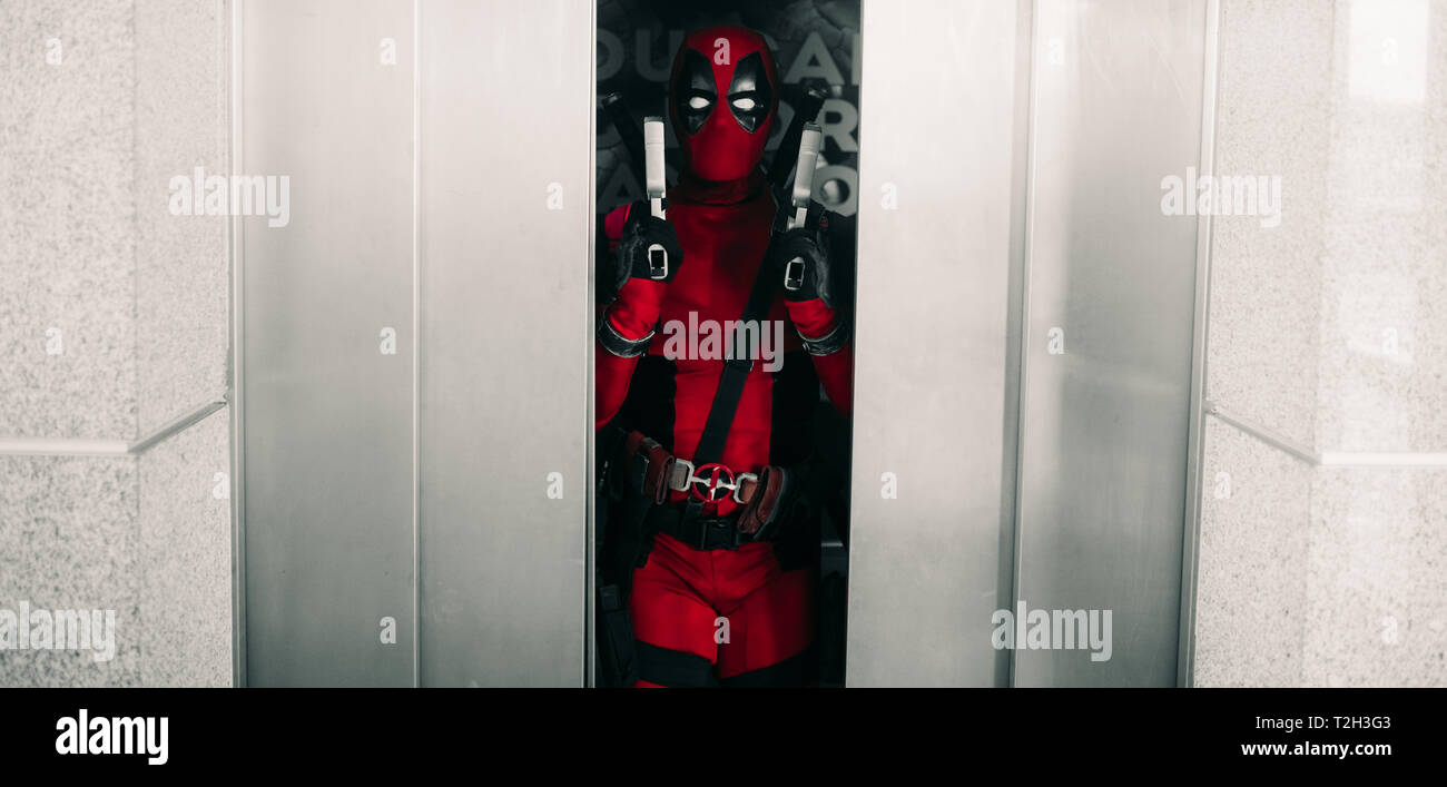 DNIPRO, UKRAINE - MARCH 28, 2019: Deadpool cosplayer posing with guns ...