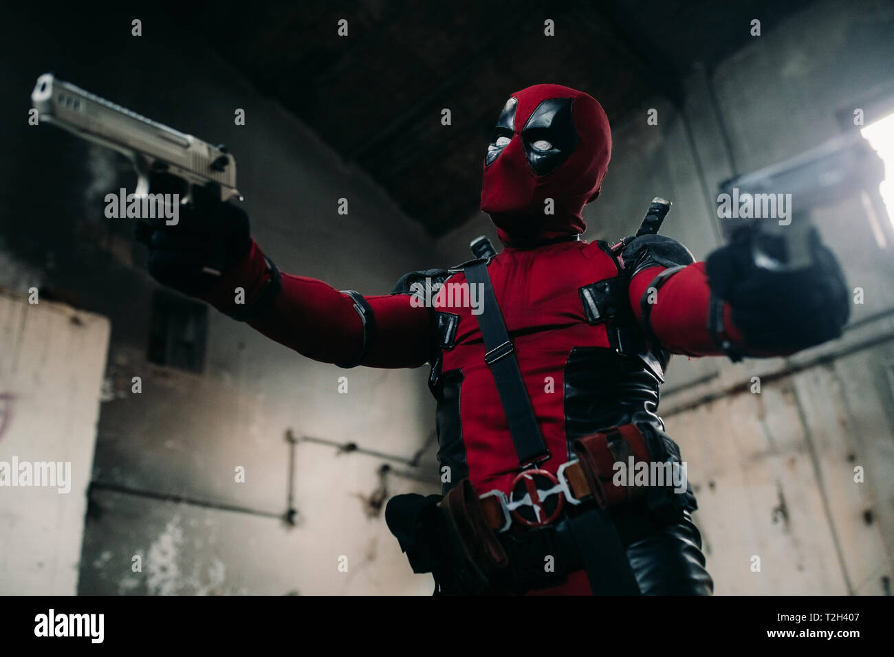 DNIPRO, UKRAINE - MARCH 28, 2019: Deadpool cosplayer posing indoors ...