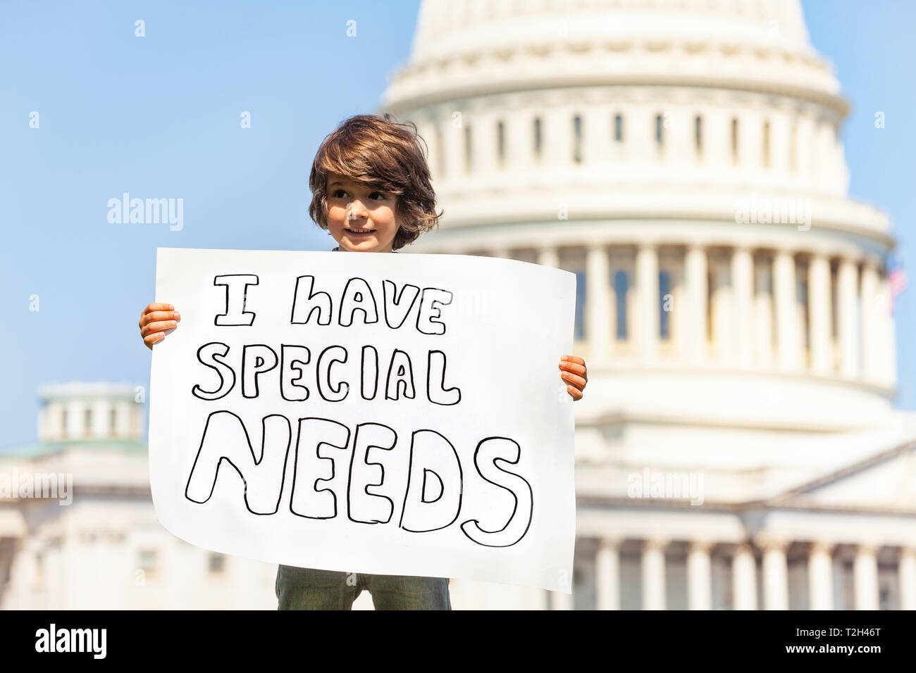 Child boy protest in front of the USA capitol in Washington holding ...