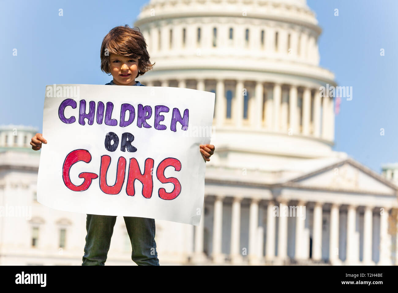 Child boy protest in front of the USA capitol in Washington holding ...