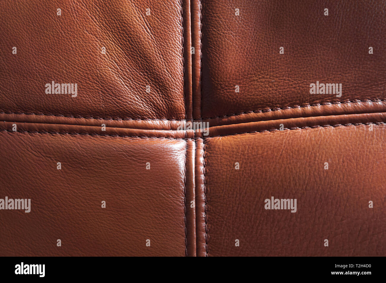 Genuine leather with seams, brown background texture, close up photo ...