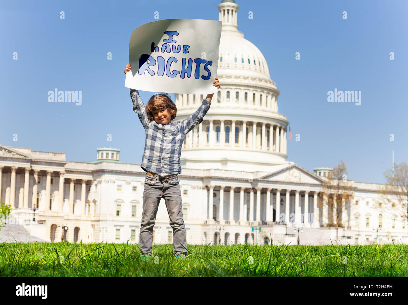 Child boy protest in front of the USA capitol in Washington holding ...