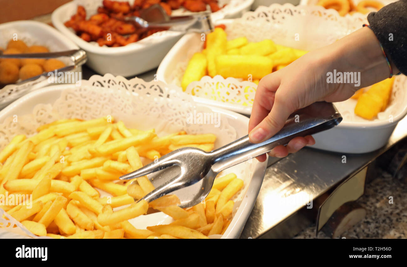 self service with yellow hot chips and more foods Stock Photo - Alamy