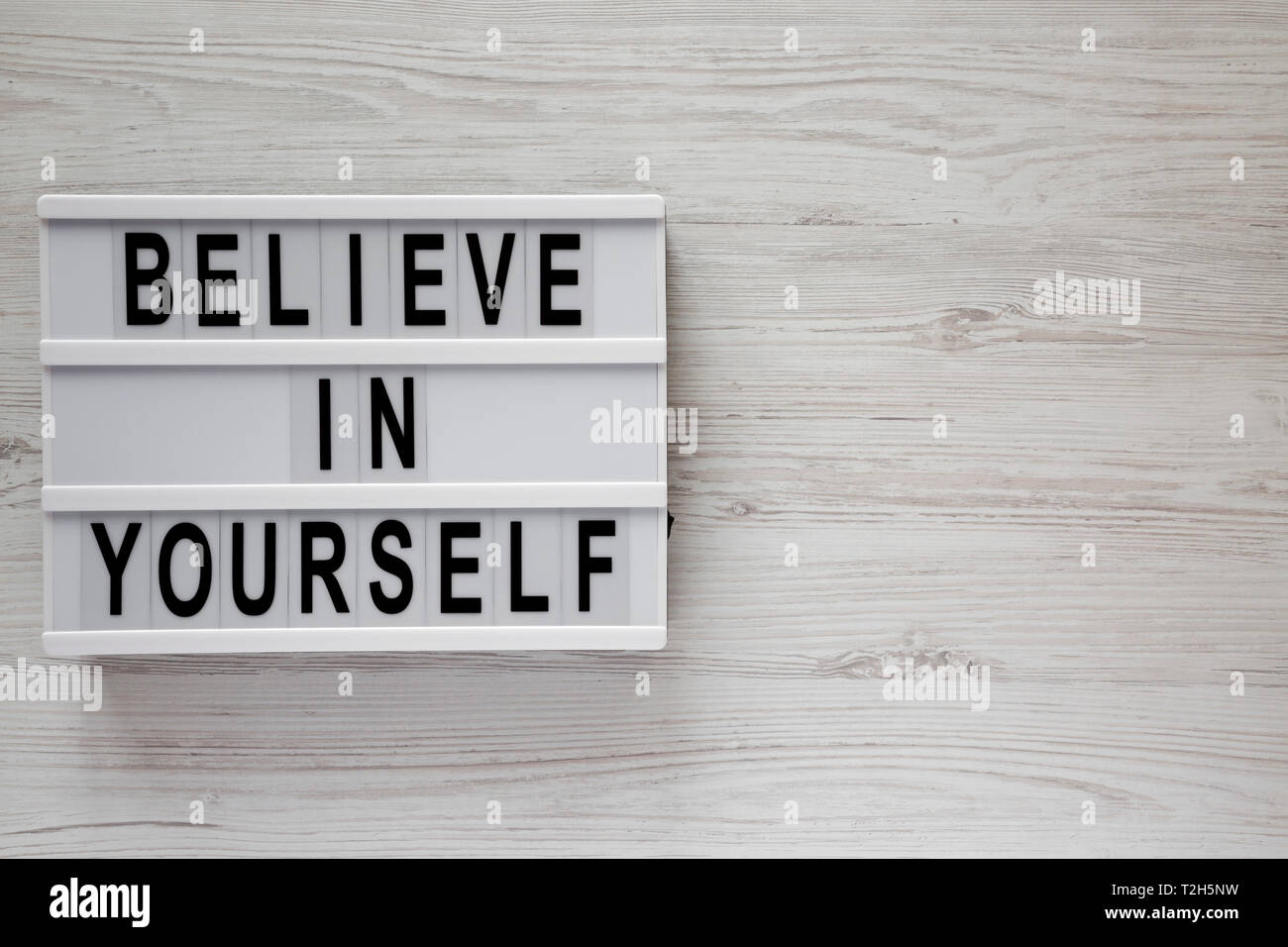 'Believe in yourself' words on lightbox on a white wooden surface, top ...