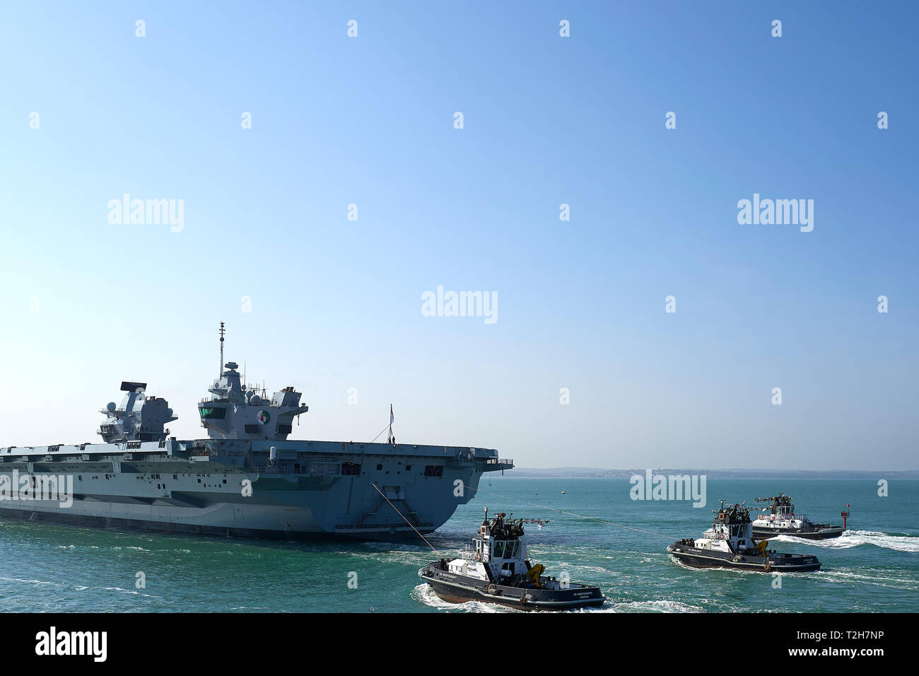 The Royal Navy Aircraft Carrier, HMS QUEEN ELIZABETH, Being Assisted By ...