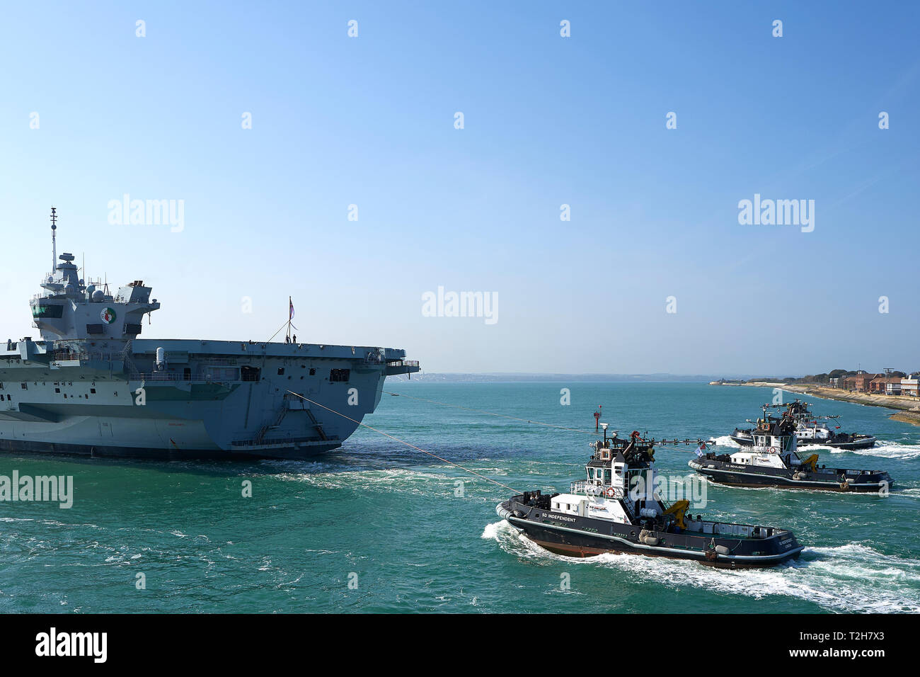 The Royal Navy Aircraft Carrier, HMS QUEEN ELIZABETH, Being Assisted By ...