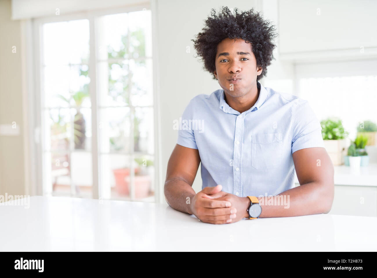 African American business man puffing cheeks with funny face. Mouth ...