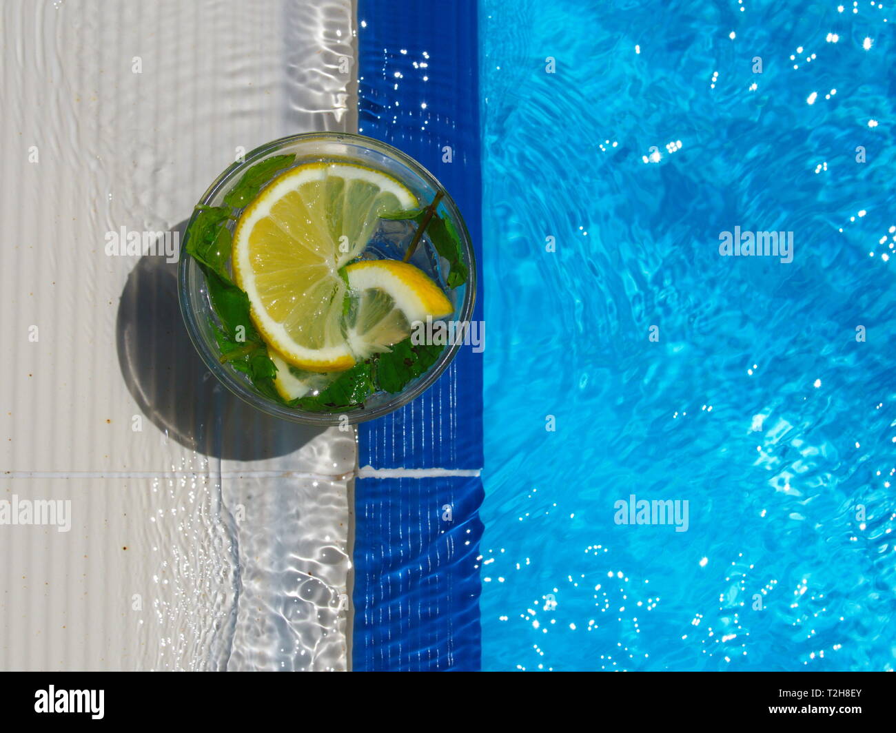 enjoying fresh lemon and mint mojito cocktail by the pool Stock Photo ...
