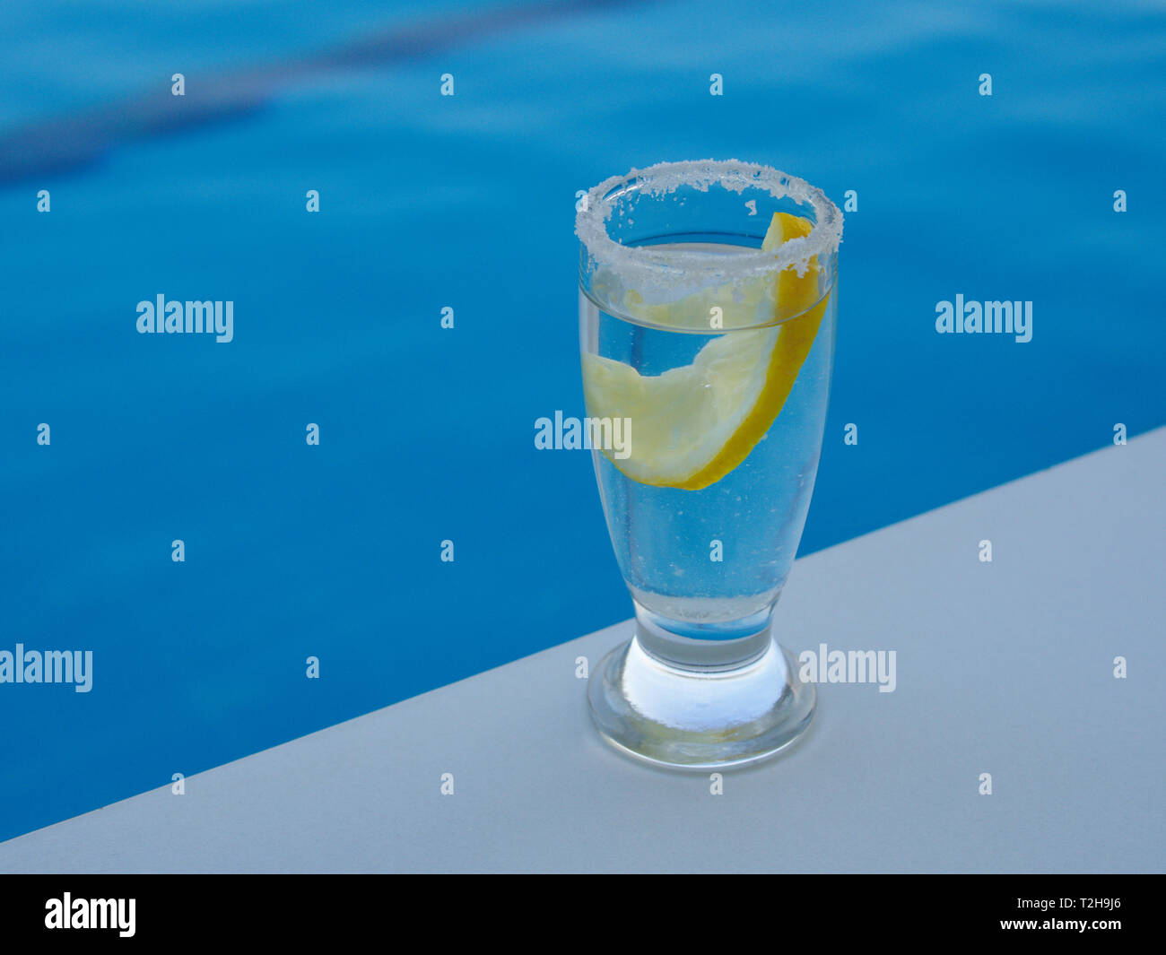 fresh lemon and salted tequila shot by the pool Stock Photo - Alamy