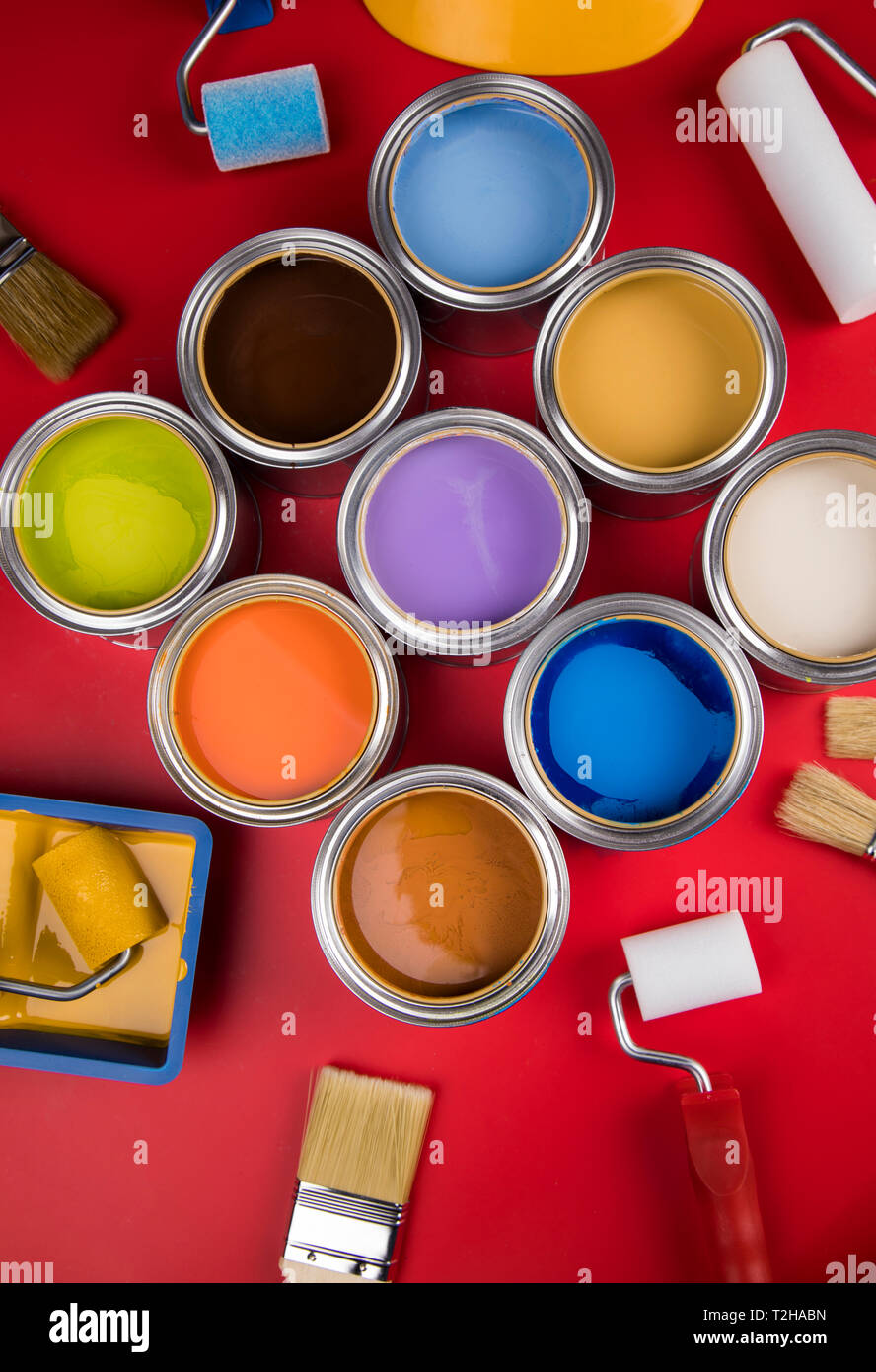 Open buckets with a paint and brush, red background Stock Photo - Alamy