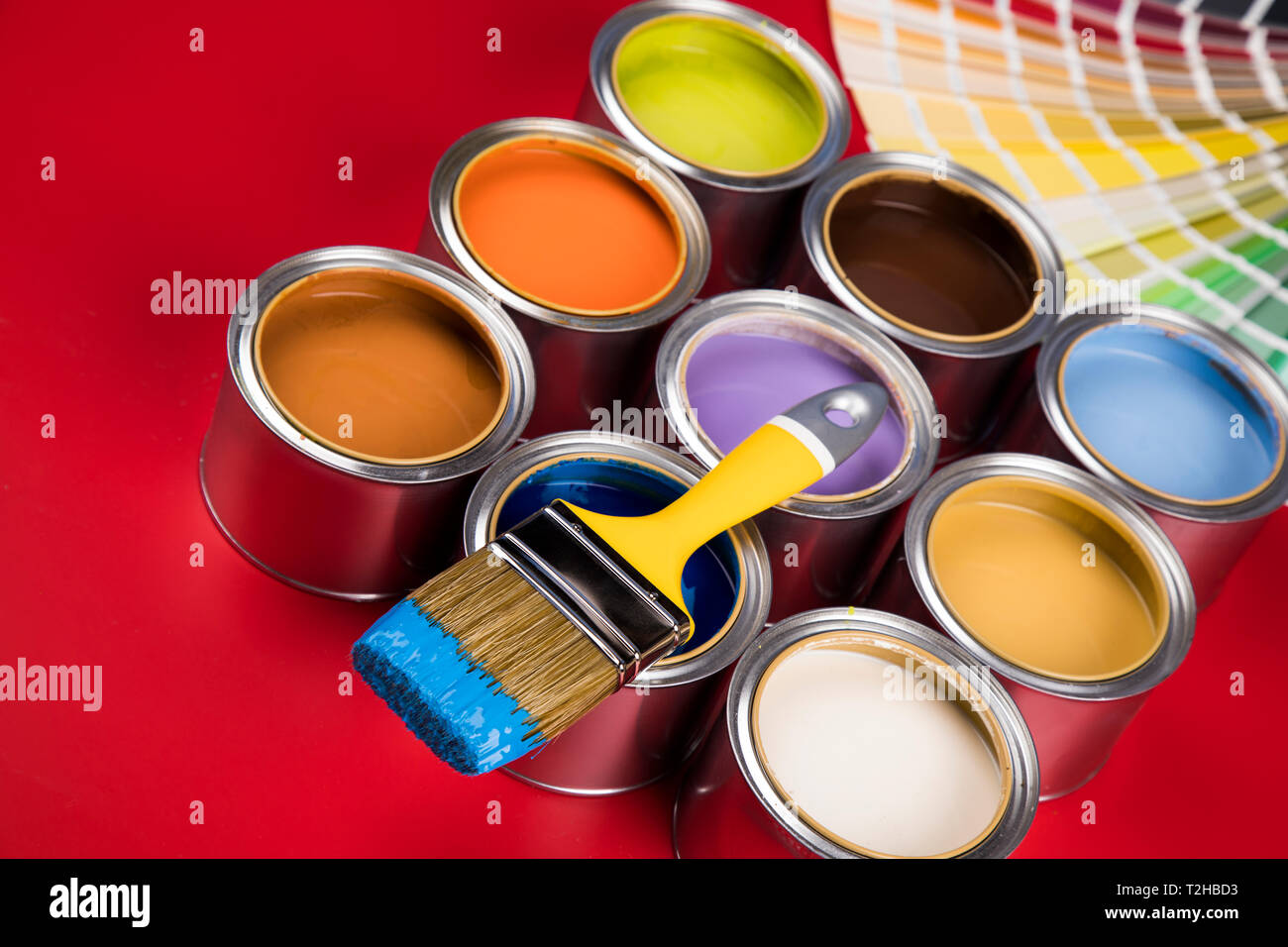 Full Buckets of rainbow colored oil paint on red background Stock Photo ...