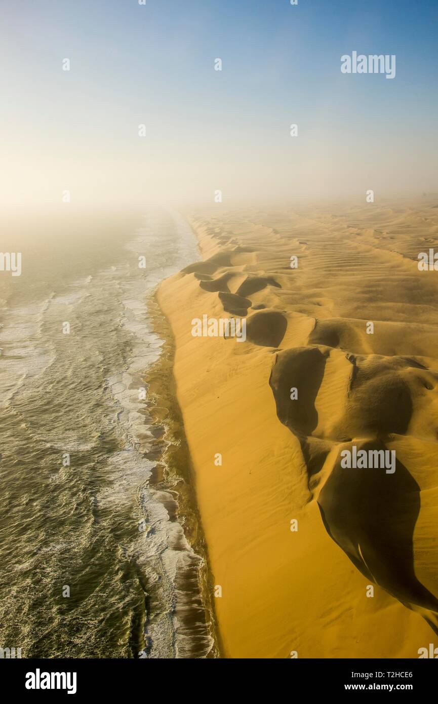 Aerial view, sandunes of the Namib desert floating in the Atlantic ...