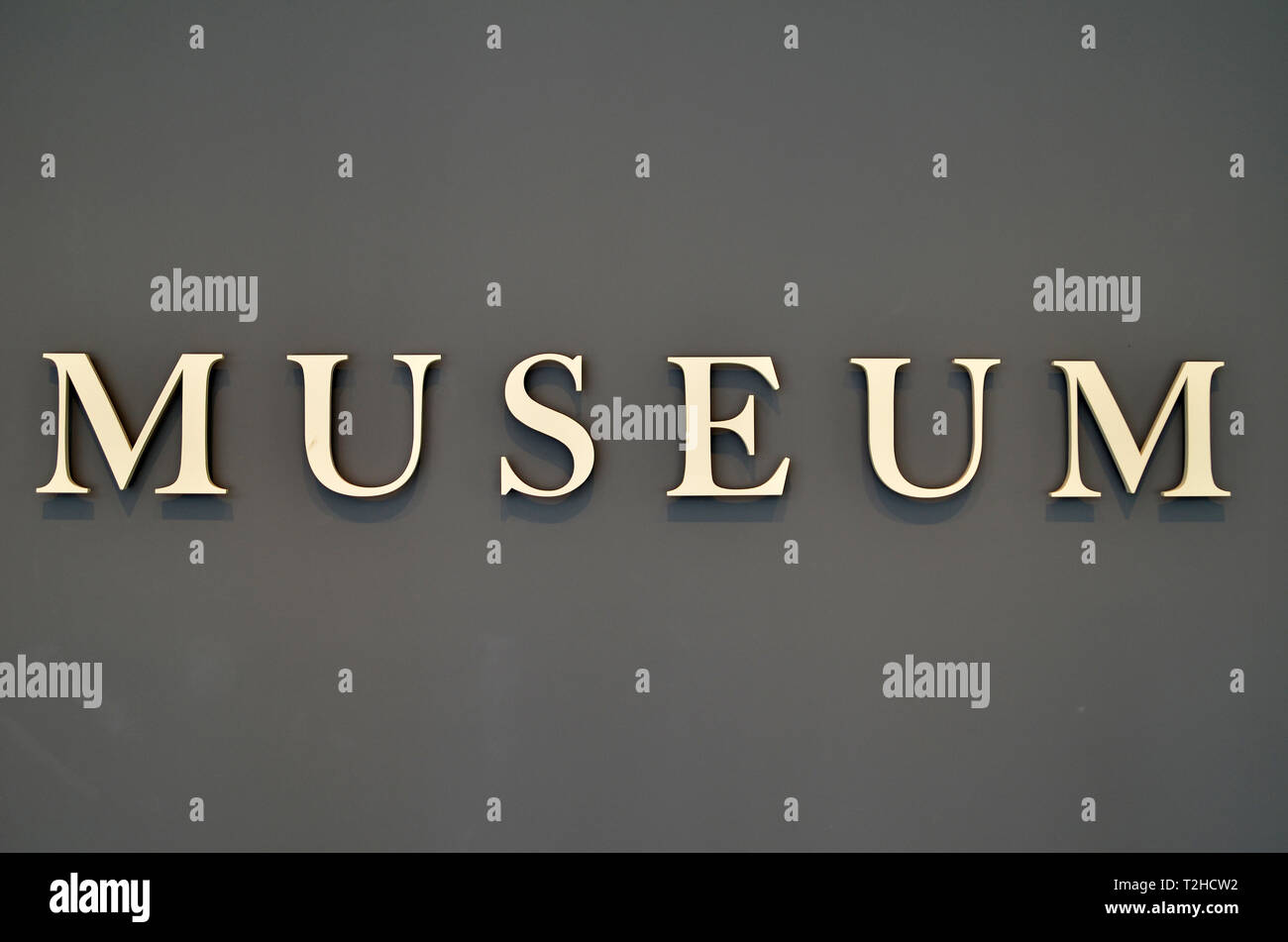 Sign for a museum agaist gray background Stock Photo - Alamy