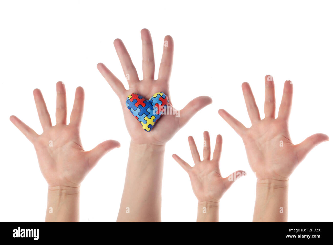 Autism awareness concept with hand and heart of puzzle pieces as symbol ...