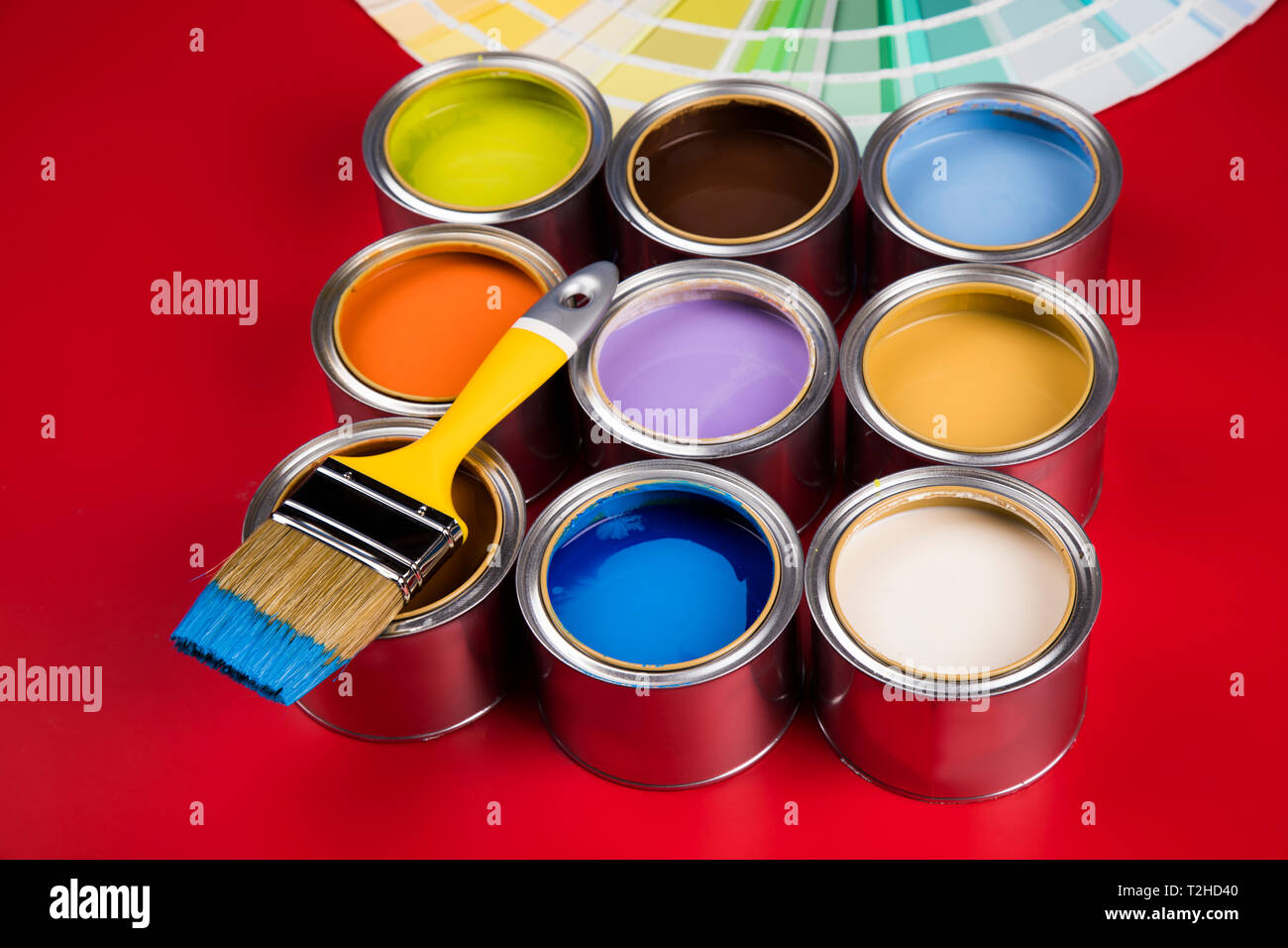 Open buckets with a paint and brush, red background Stock Photo - Alamy