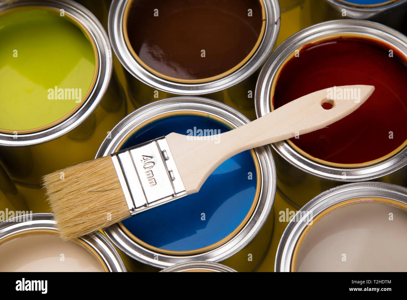 Metal tin cans with color paint and paintbrush Stock Photo - Alamy