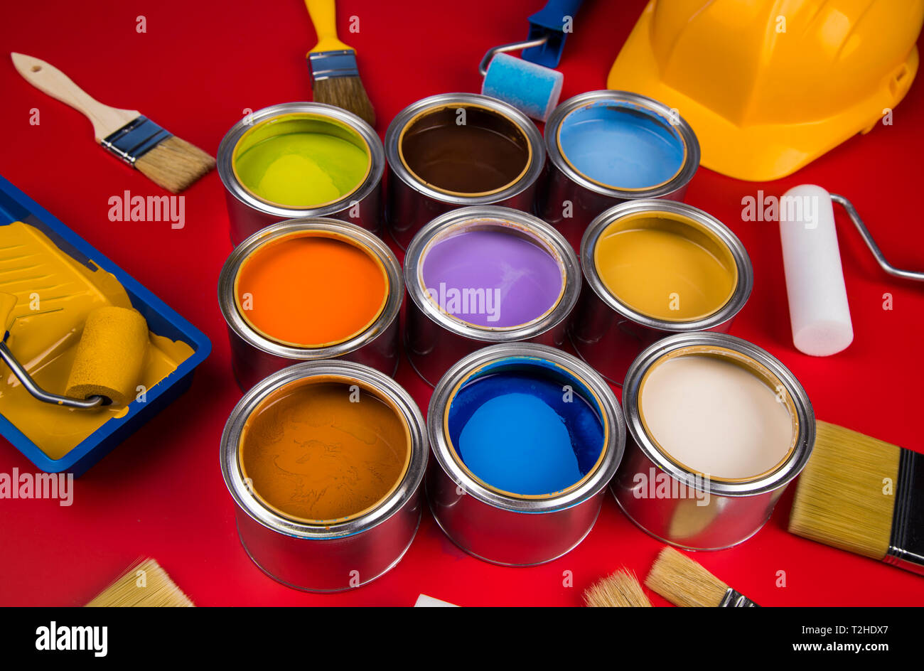 Full Buckets of rainbow colored oil paint on red background Stock Photo ...