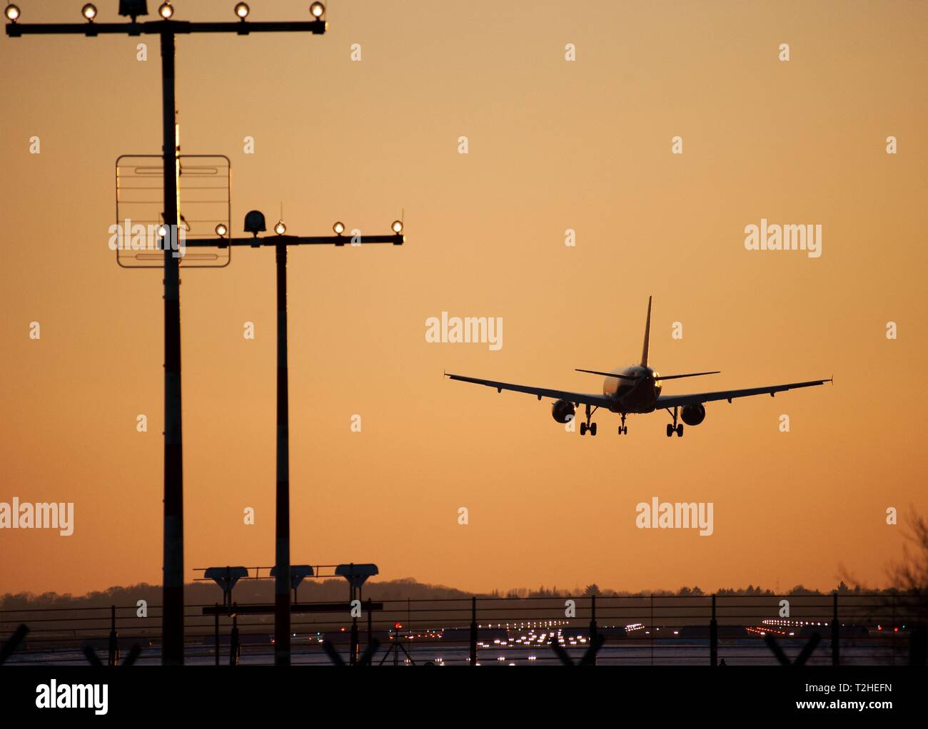 Approach aircraft at sunset, approach lighting, Dusseldorf Airport ...