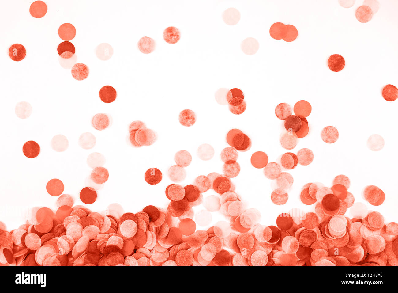 Bright coral confetti isolated on a white background. Festive concept ...