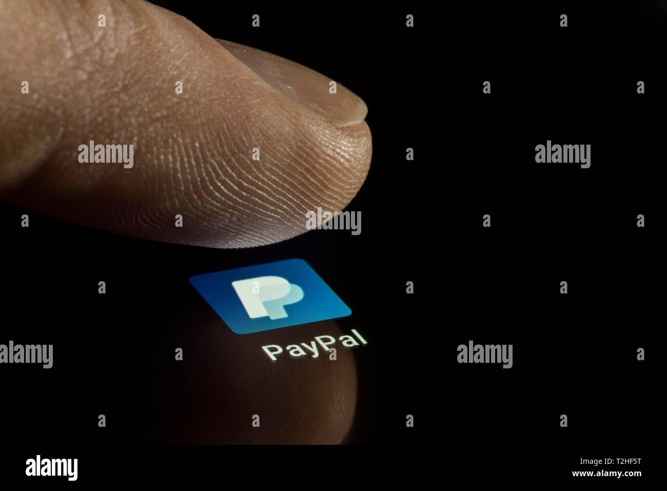 PayPal app icon on a display, with finger, mobile phone, smartphone ...