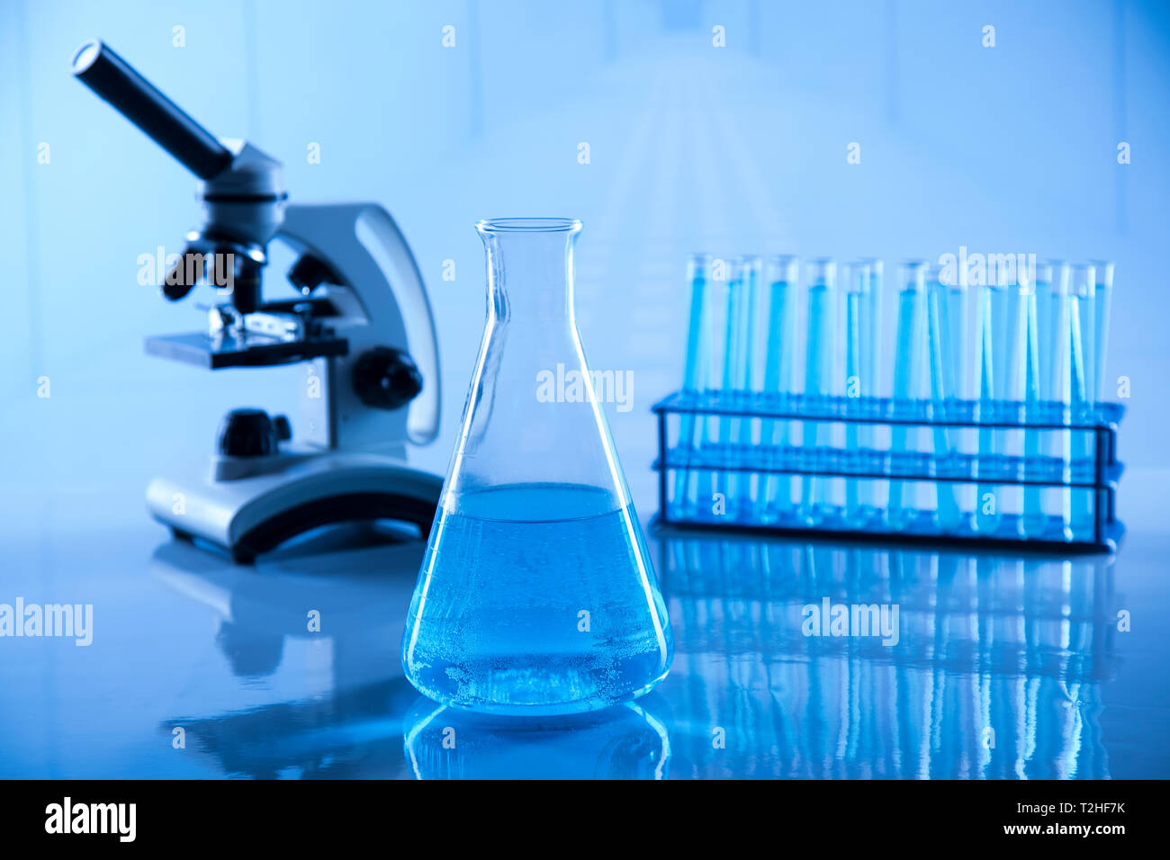 Laboratory beakers,Science experiment, blue background Stock Photo - Alamy