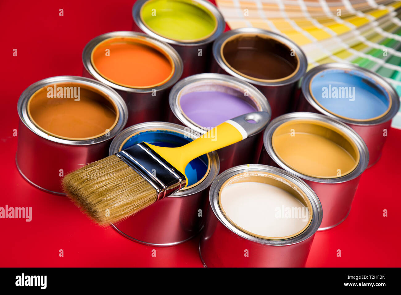 Collection of colored paints cans, Brush, red background Stock Photo ...