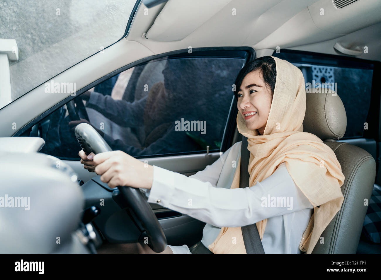 portrait of asian muslim woman with hijab driving a car Stock Photo - Alamy