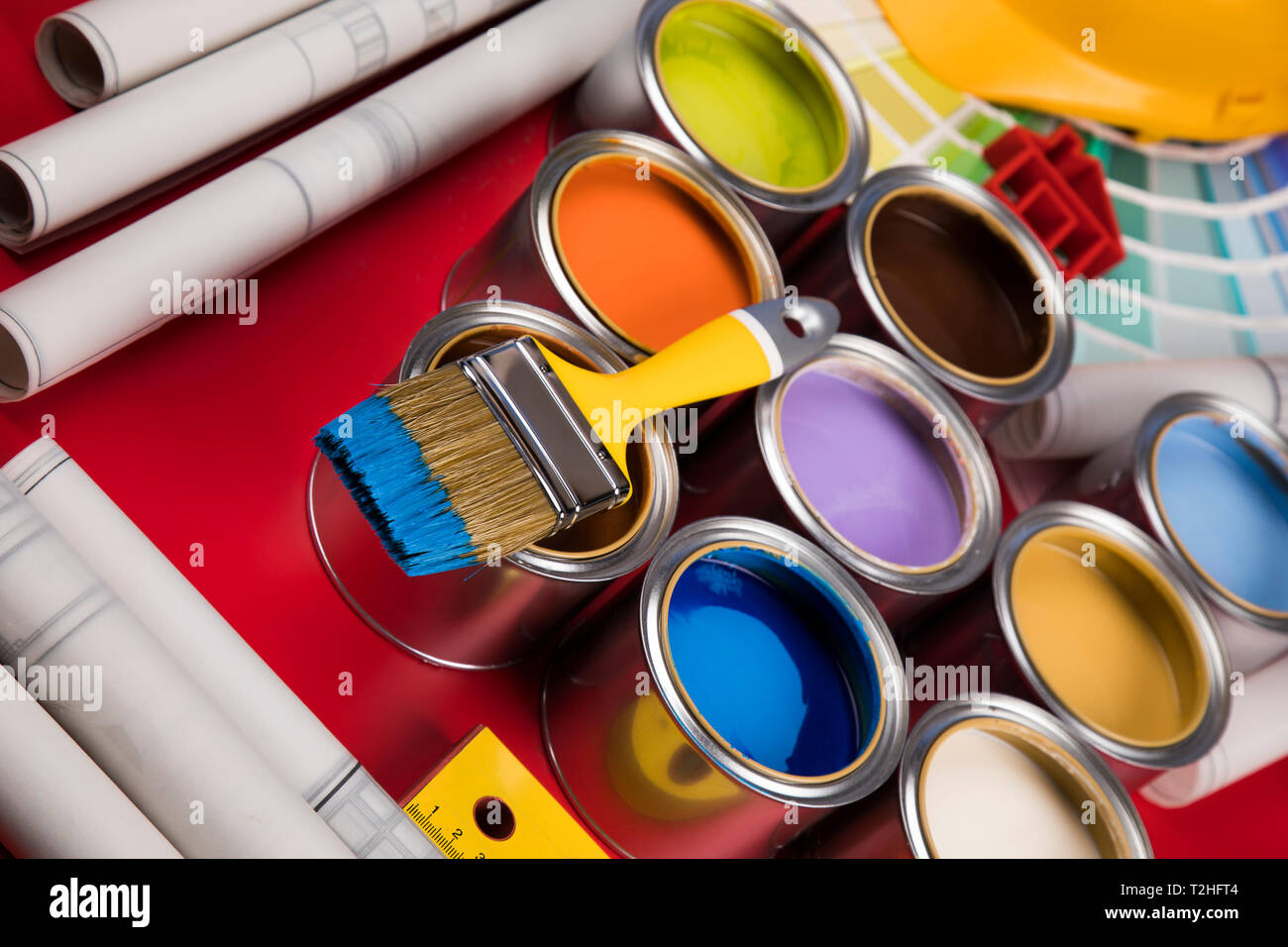 Open buckets with a paint and brush, red background Stock Photo - Alamy