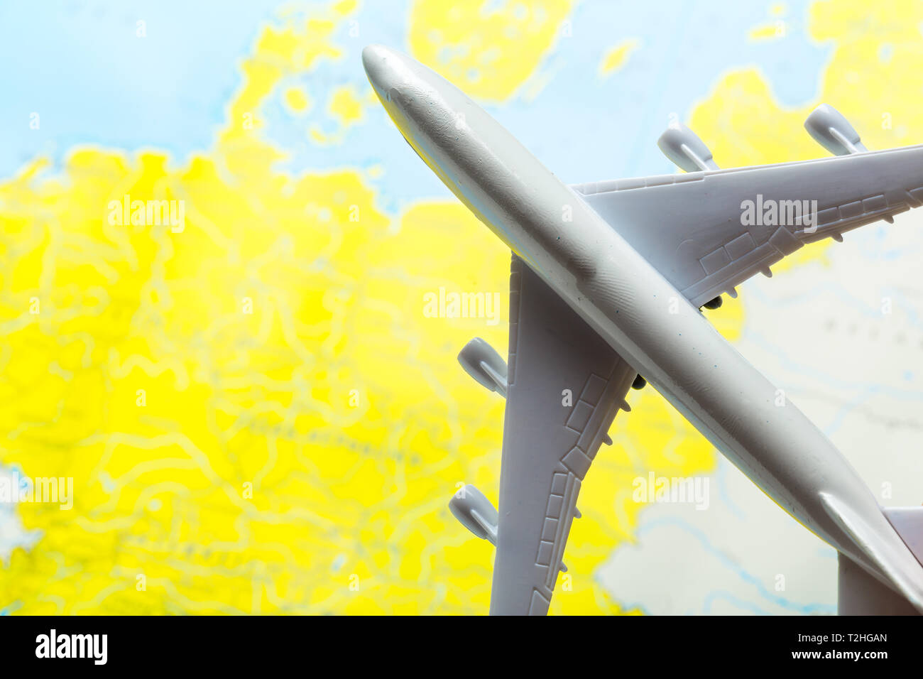 miniature of a passenger aircraft flying on a map Stock Photo - Alamy