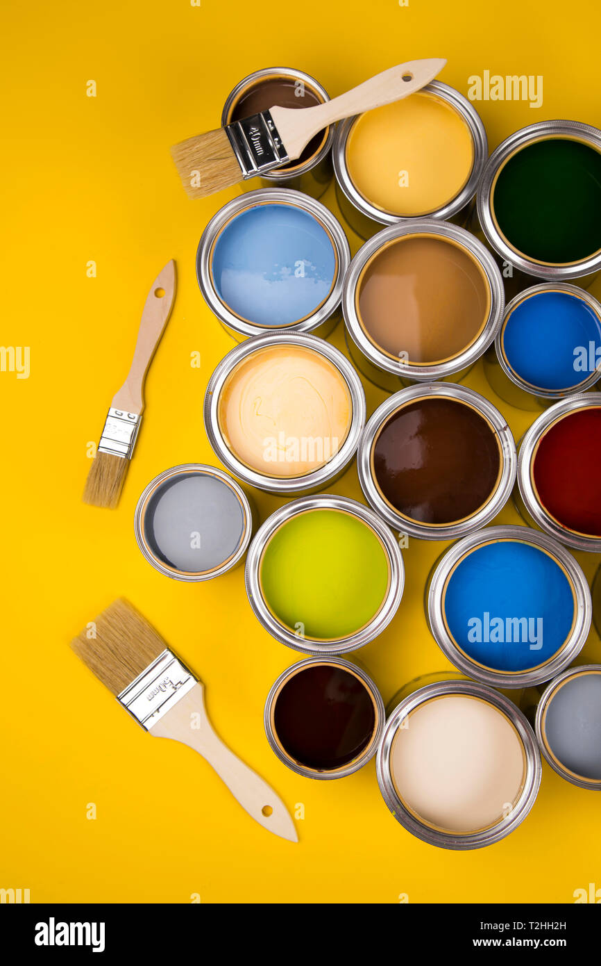 Metal tin cans with color paint and paintbrush Stock Photo - Alamy