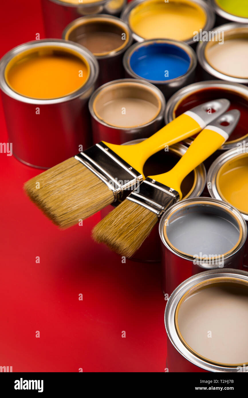 Collection of colored paints cans, Brush, red background Stock Photo ...
