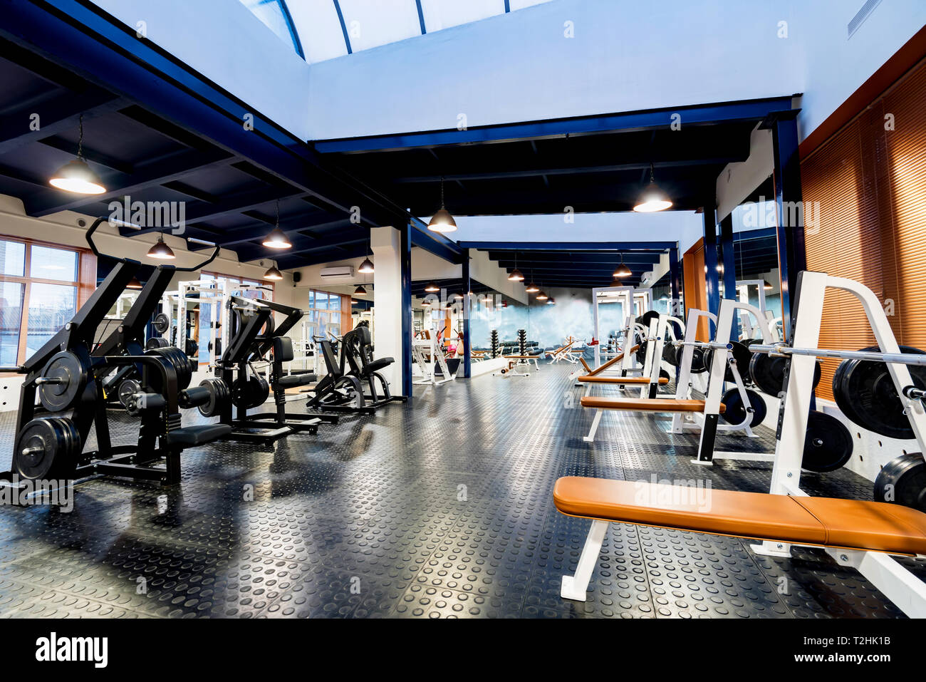 Interior with several modern fitness machines in gym Stock Photo - Alamy
