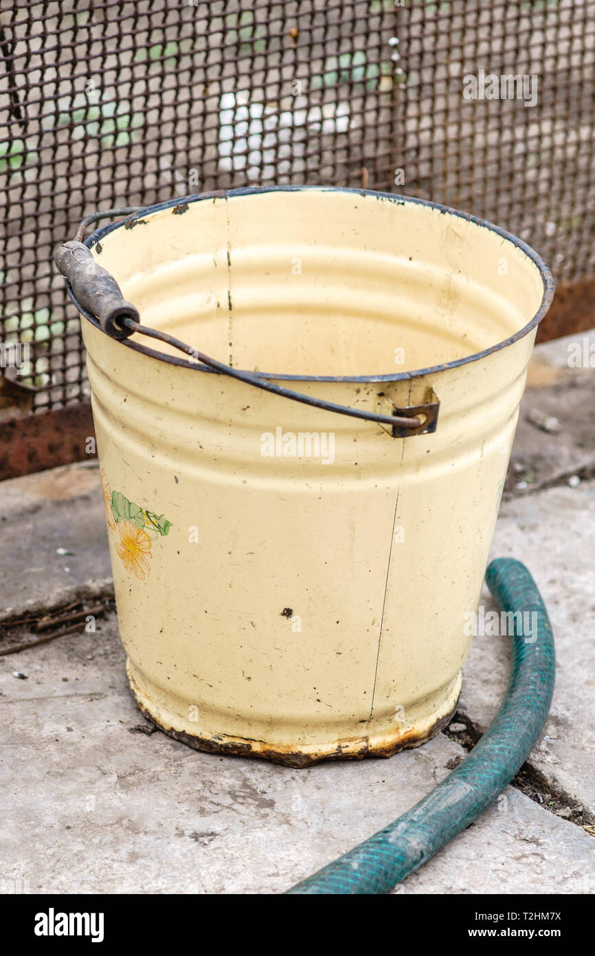 An old iron bucket stands in a rural yard Stock Photo - Alamy