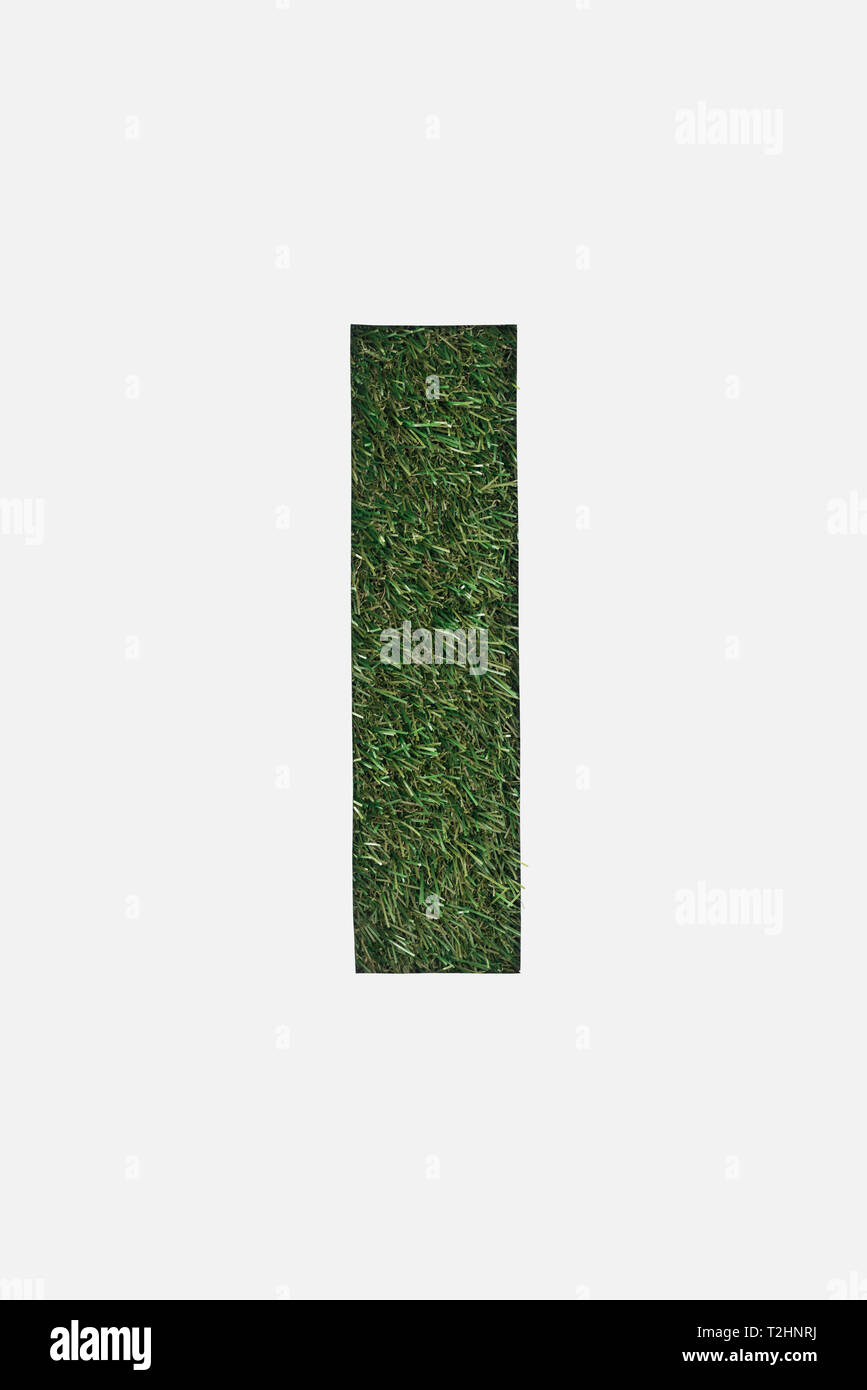 top view of cut out I letter on green grass background isolated on ...