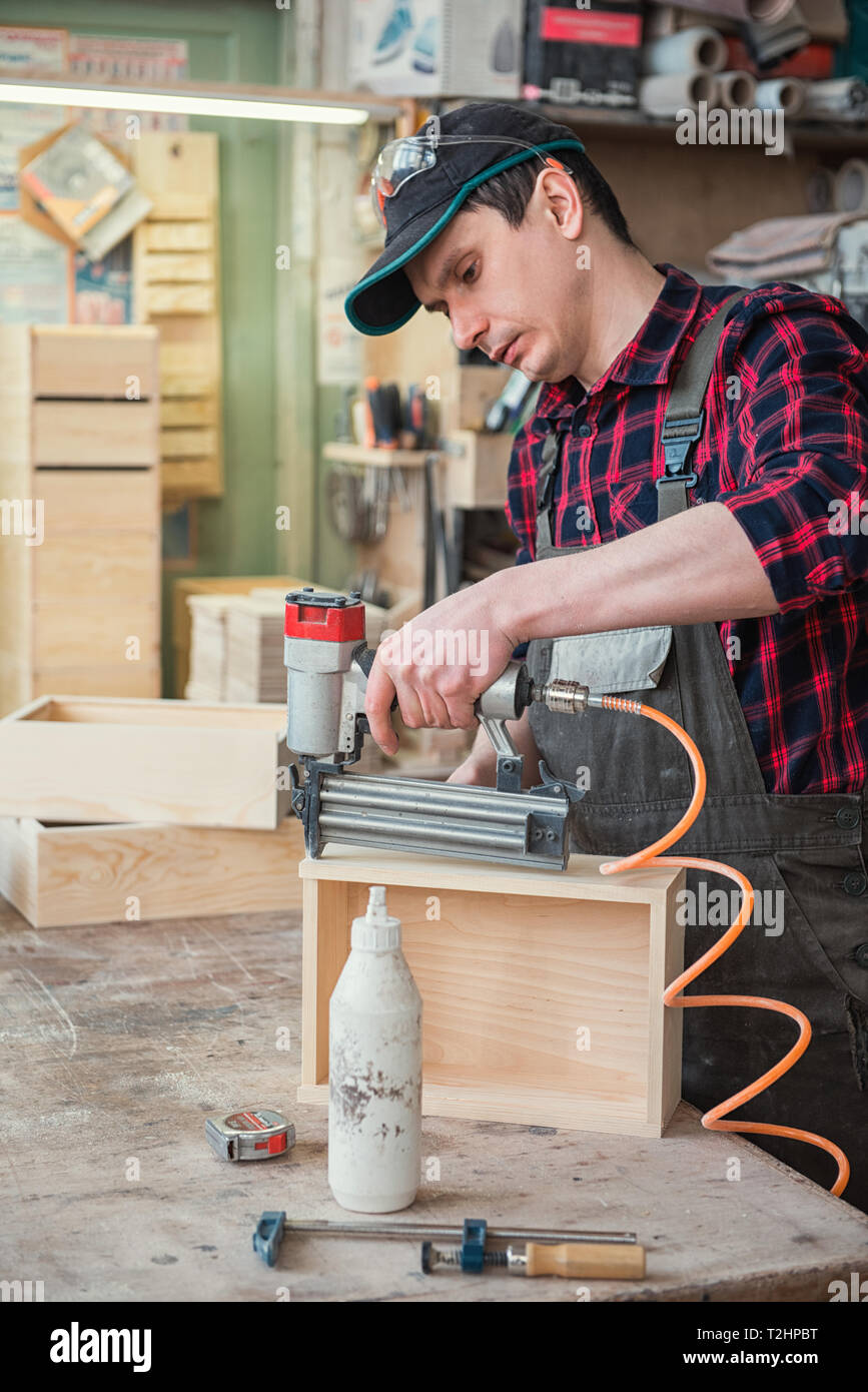 Worker making the wood box. Profession, carpentry and woodwork concept ...