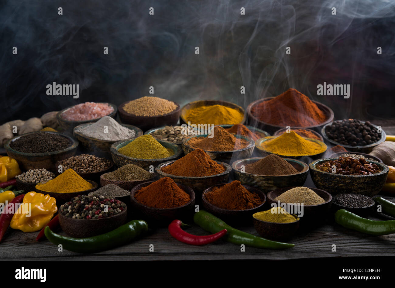 Smoke, Aromatic spices on wooden background Stock Photo - Alamy