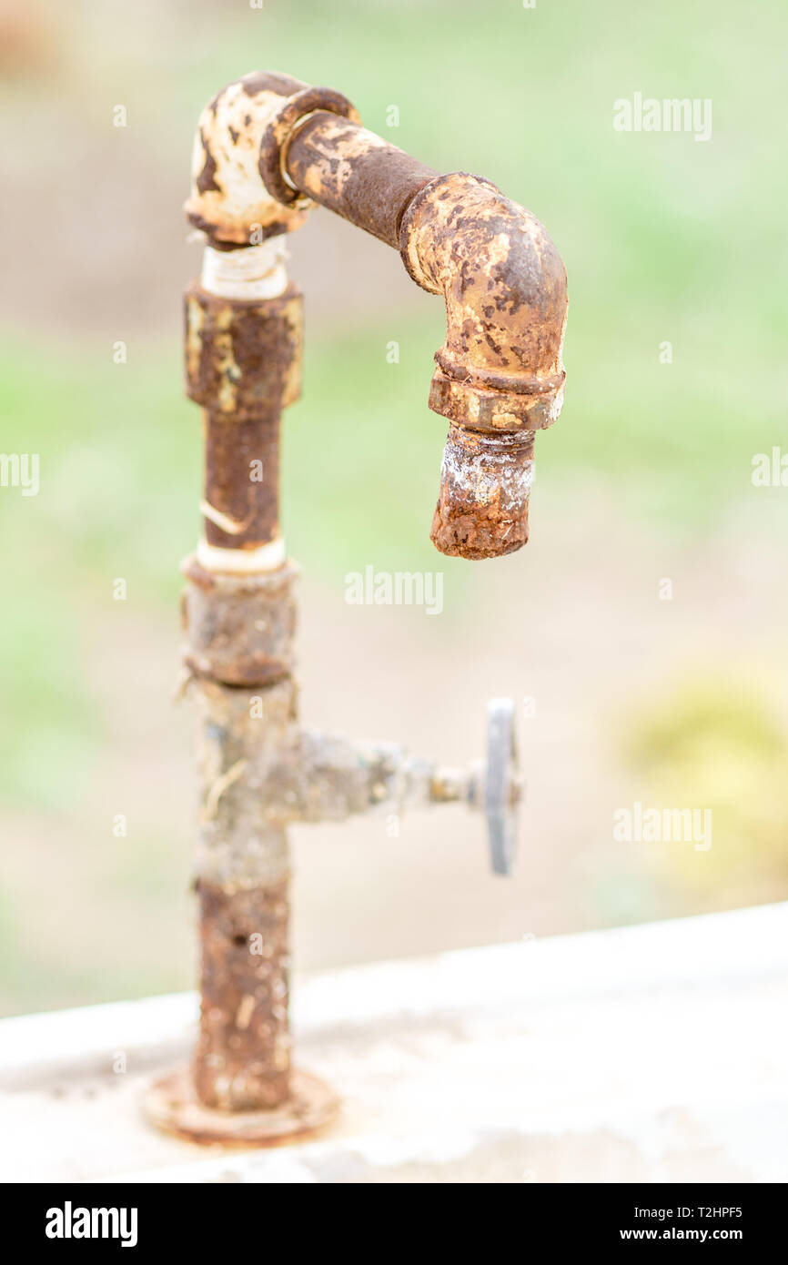 Old rusty water tap in the garden. Macro shot Stock Photo - Alamy