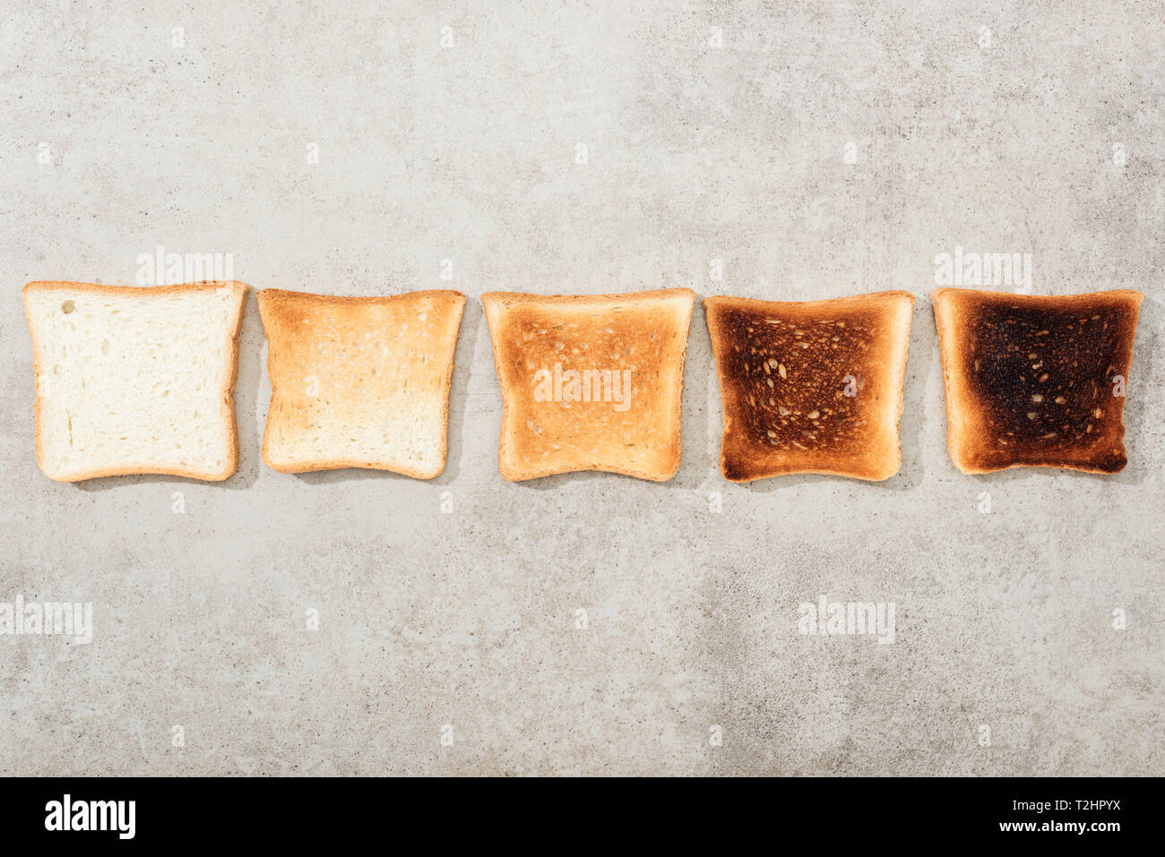 Top view of bread toasts on grey textured surface Stock Photo - Alamy