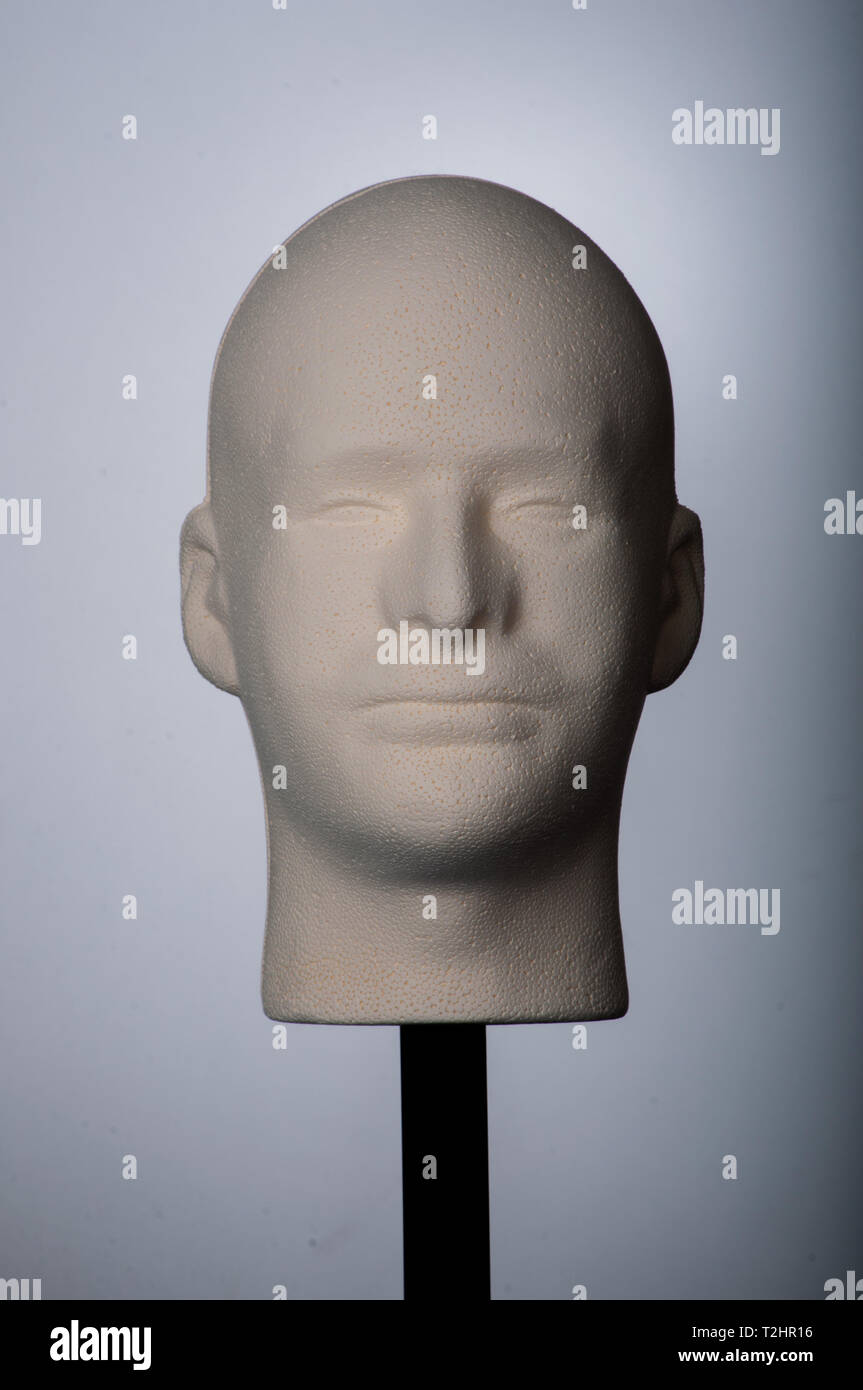 front portrait white mannequin head on stick with gray background Stock ...