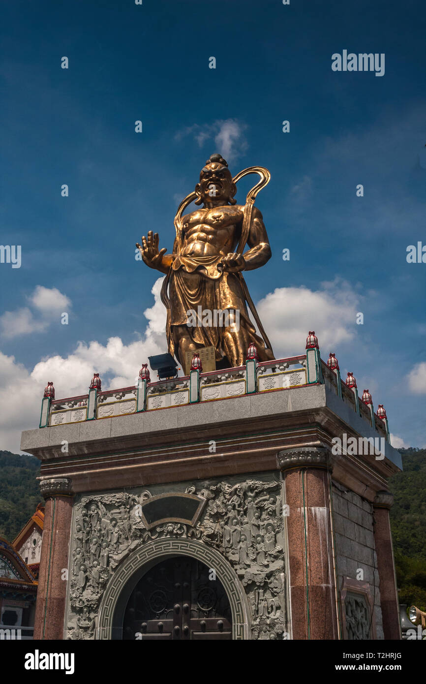 A statue of a mythological guardian at Kek Lok Si Temple, the ornate ...
