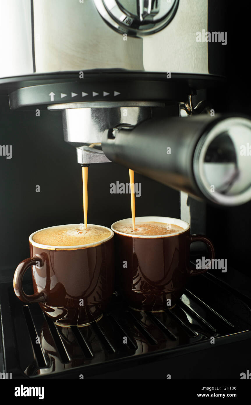 Espresso coffee pouring from coffee machine. Professional coffee ...