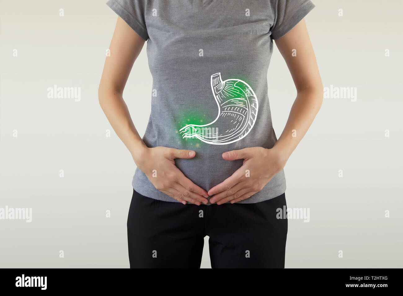 Digital composite of highlighted green stomach of woman with infection ...
