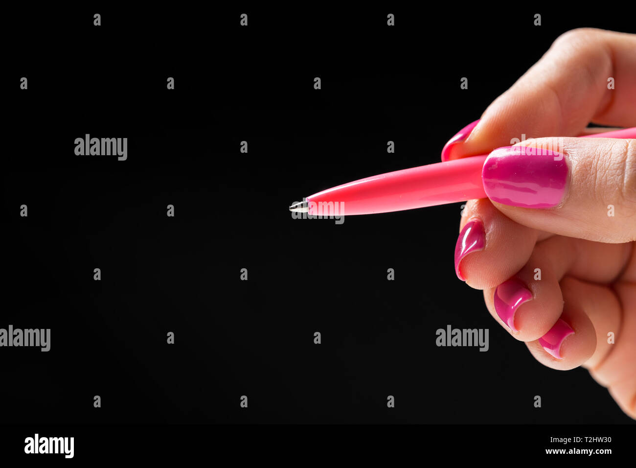 Female hand holding a pen close up Stock Photo - Alamy