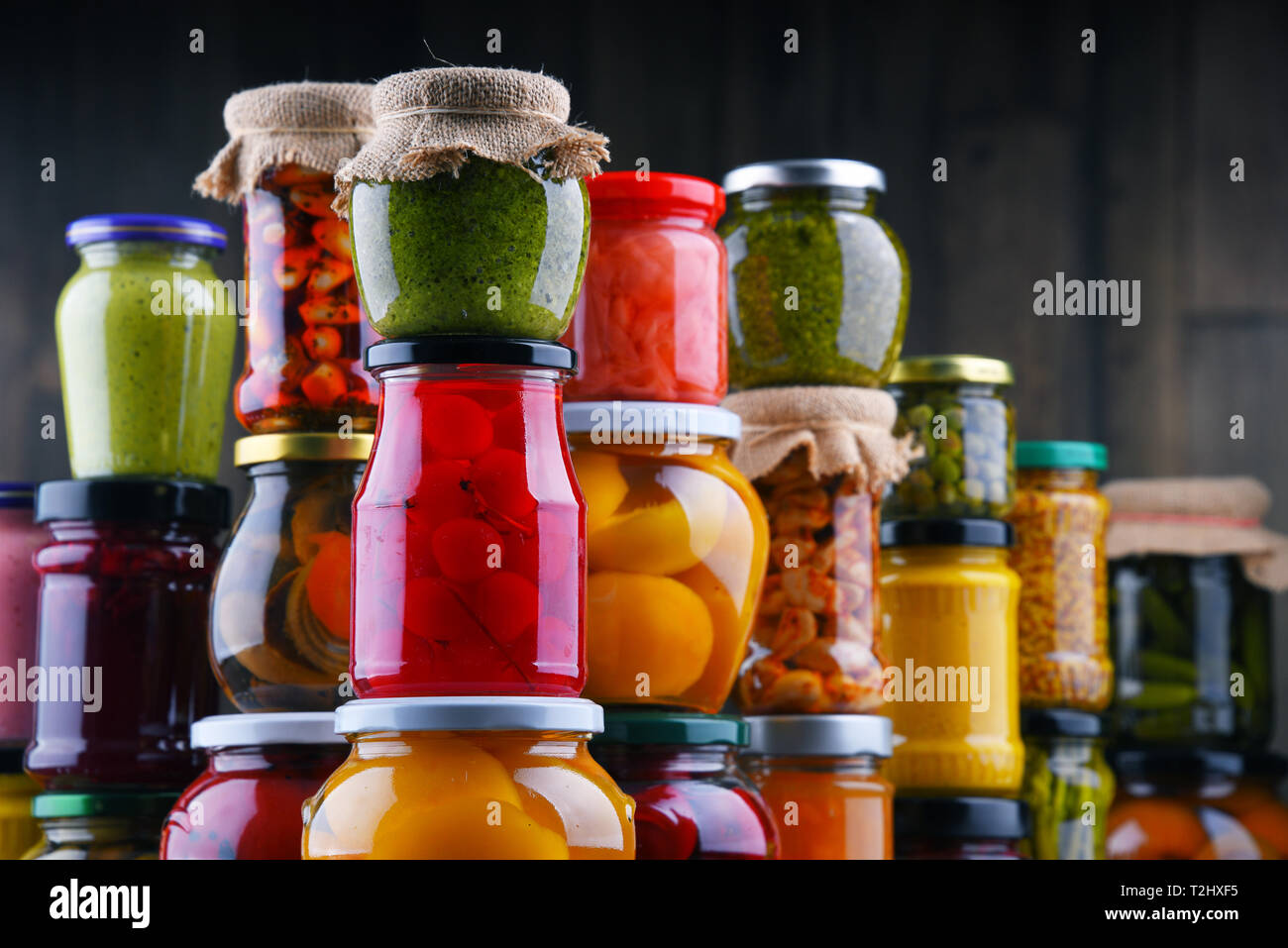 Jars with variety of pickled vegetables and fruits. Preserved food ...